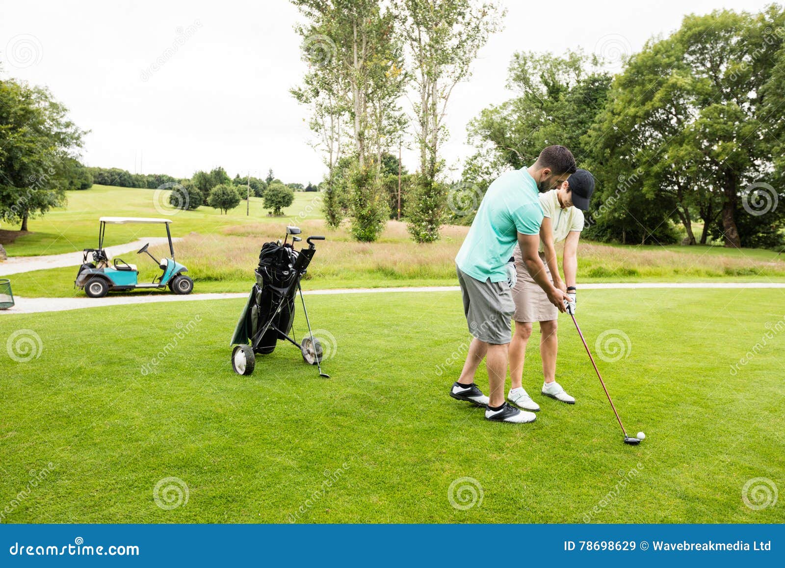 Male Instructor Assisting Woman in Learning Golf Stock Image - Image of ...
