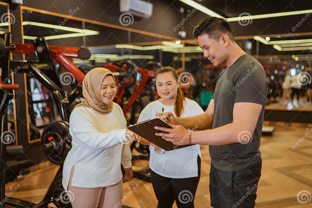 Male Instructor Explaining Trainee Workout Plan Stock Image - Image of ...