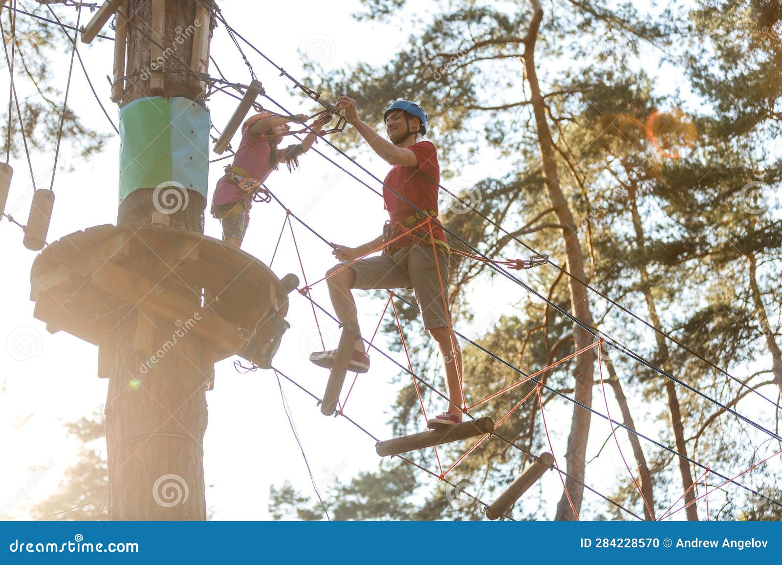 Male Instructor Helps the Child on the Rope Road in the Training Camp ...