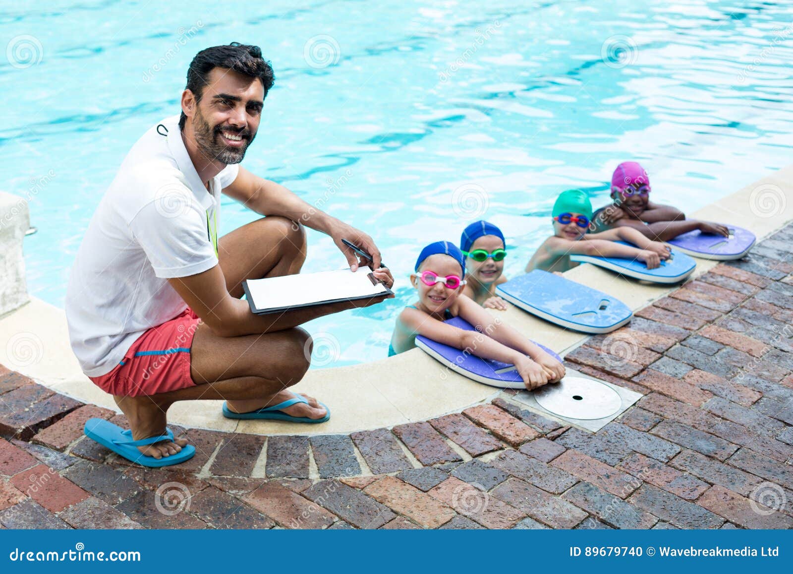 Male Instructor with Little Swimmers at Poolside Stock Photo - Image of ...