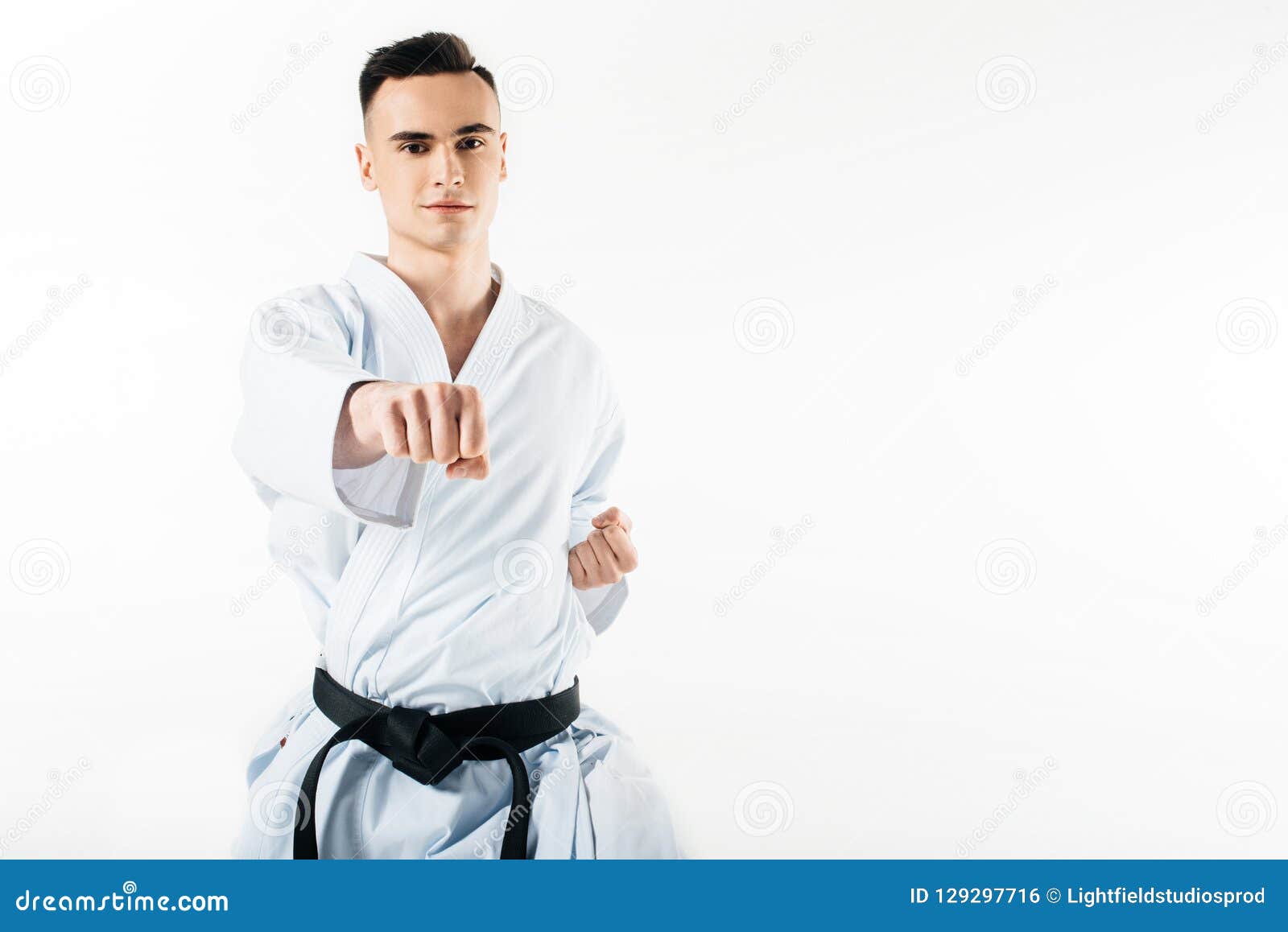 Male Karate Fighter Performing Hit and Looking at Camera Stock Photo ...