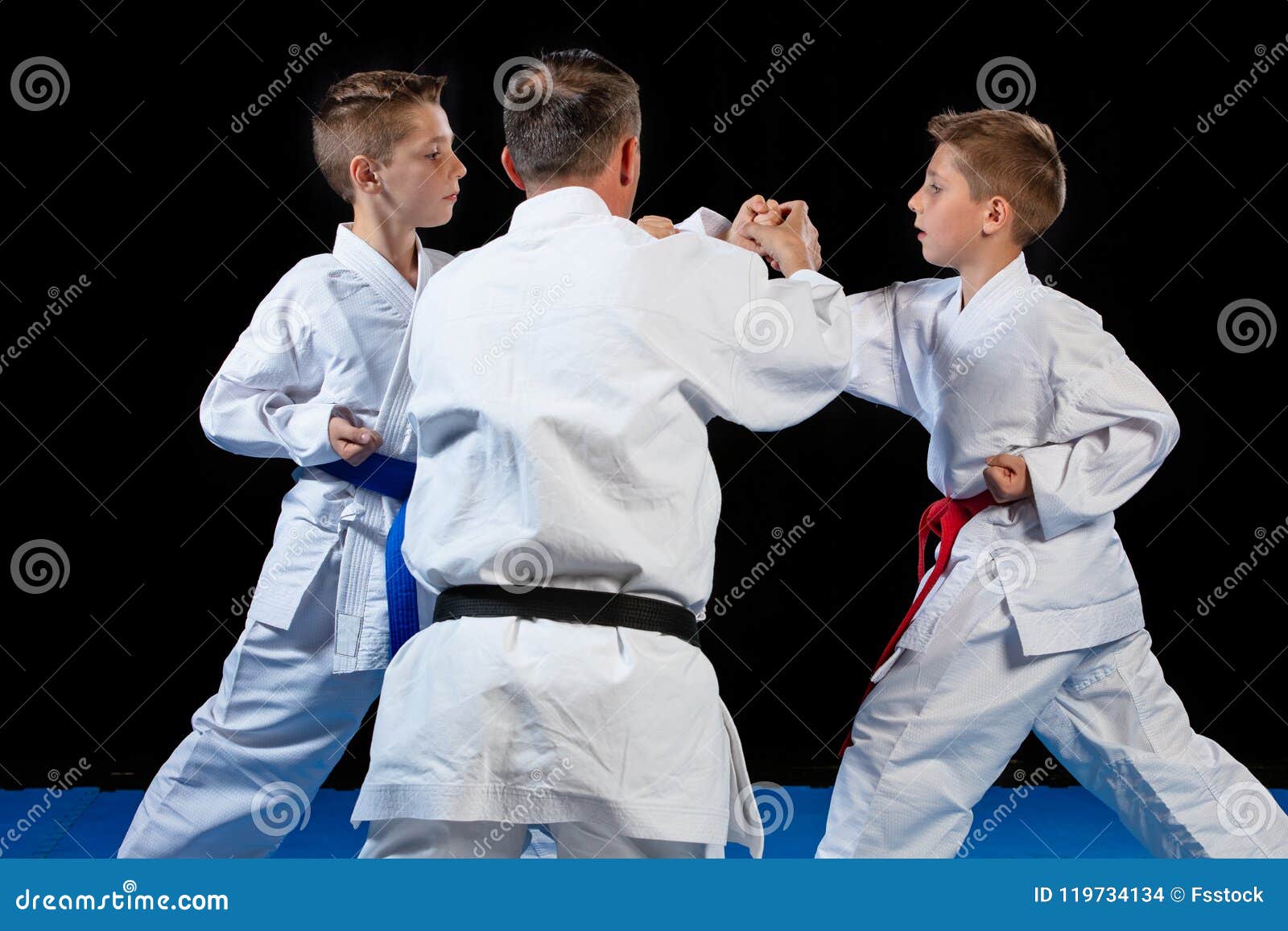 Male Karate Instructor Training Little Children in Dojo Stock Photo ...