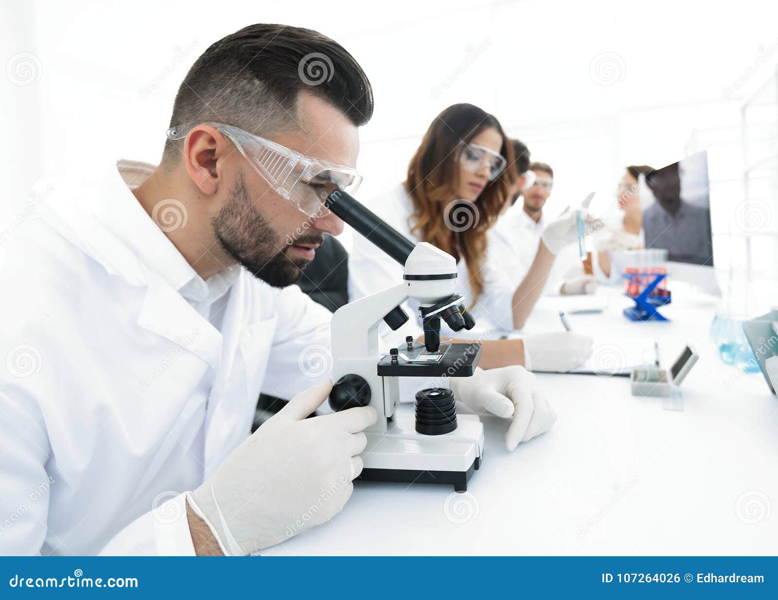 Male Lab Technician Looks at the Sample Under a Microscope Stock Photo ...
