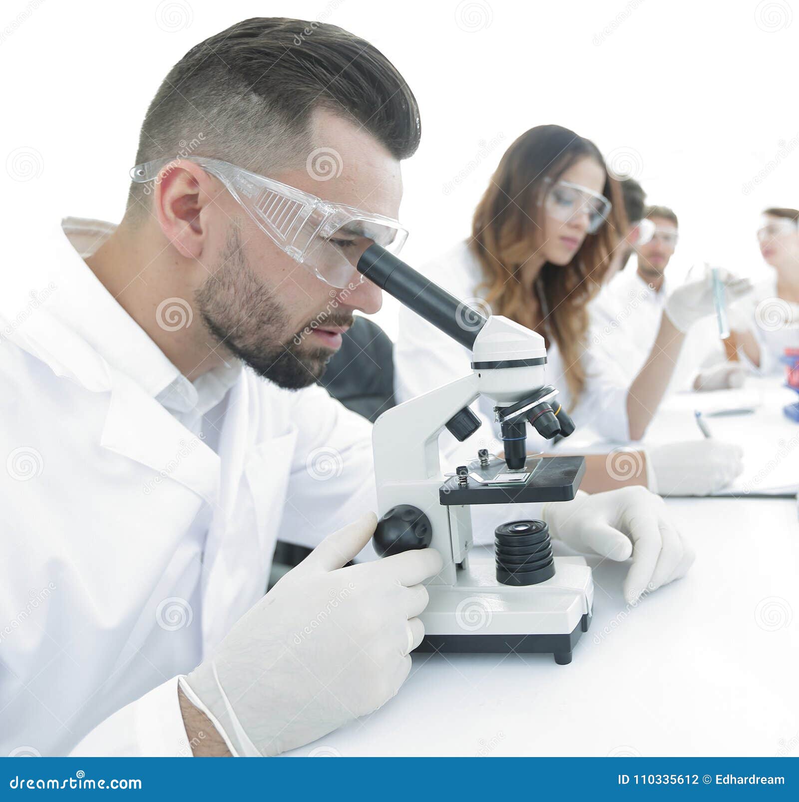Male Lab Technician Looks at the Sample Under a Microscope Stock Photo ...