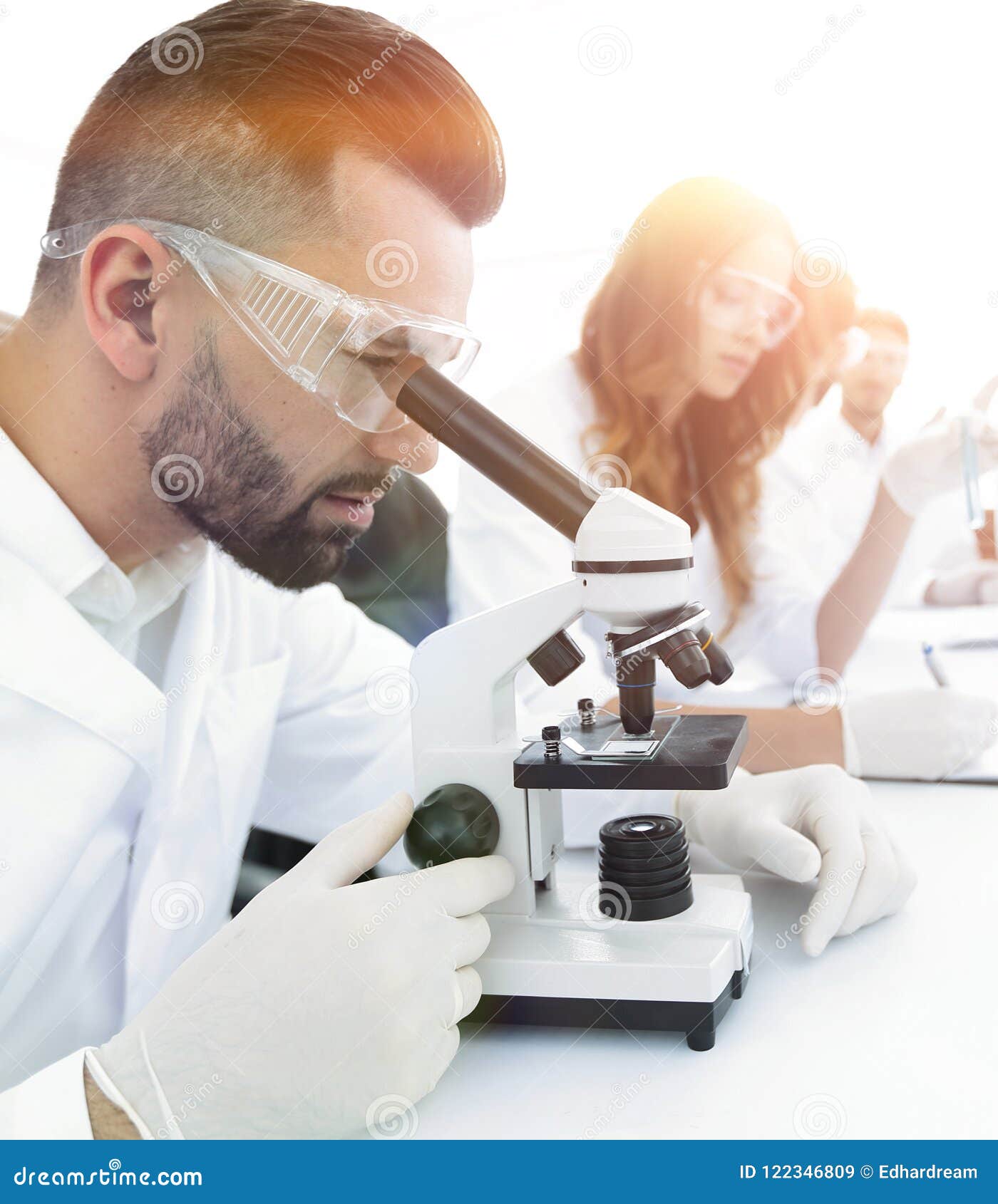 Male Lab Technician Looks at the Sample Under a Microscope Stock Image ...