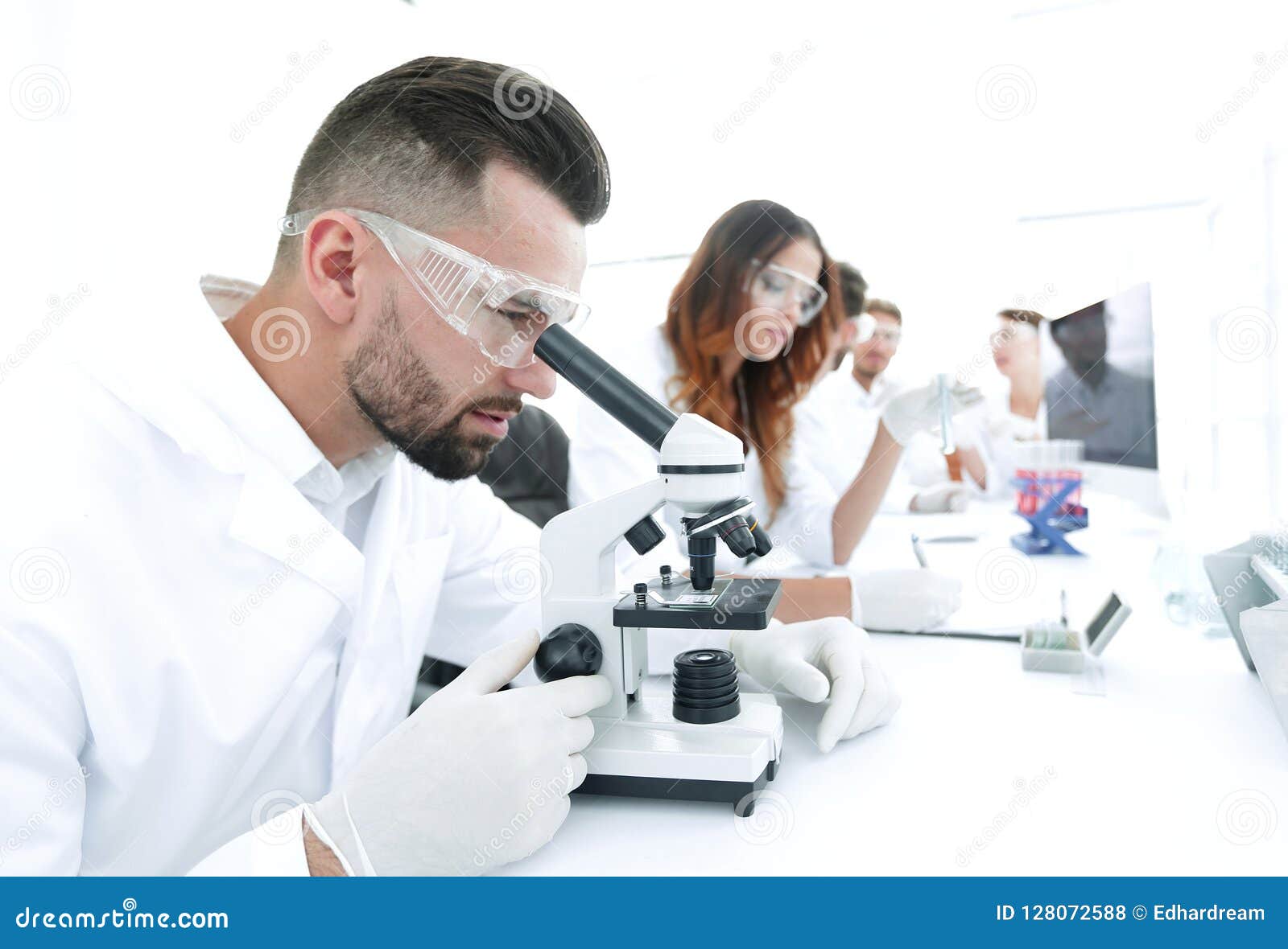 Male Lab Technician Looks at the Sample Under a Microscope Stock Photo ...