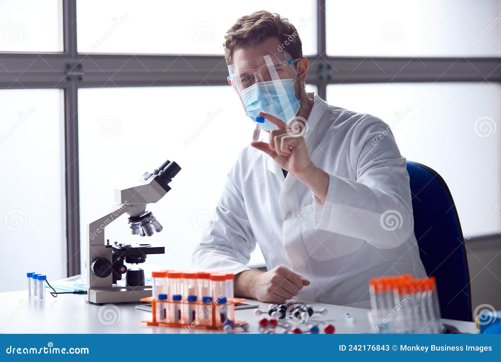 Male Lab Worker Wearing PPE Analysing Blood Samples in Laboratory with ...