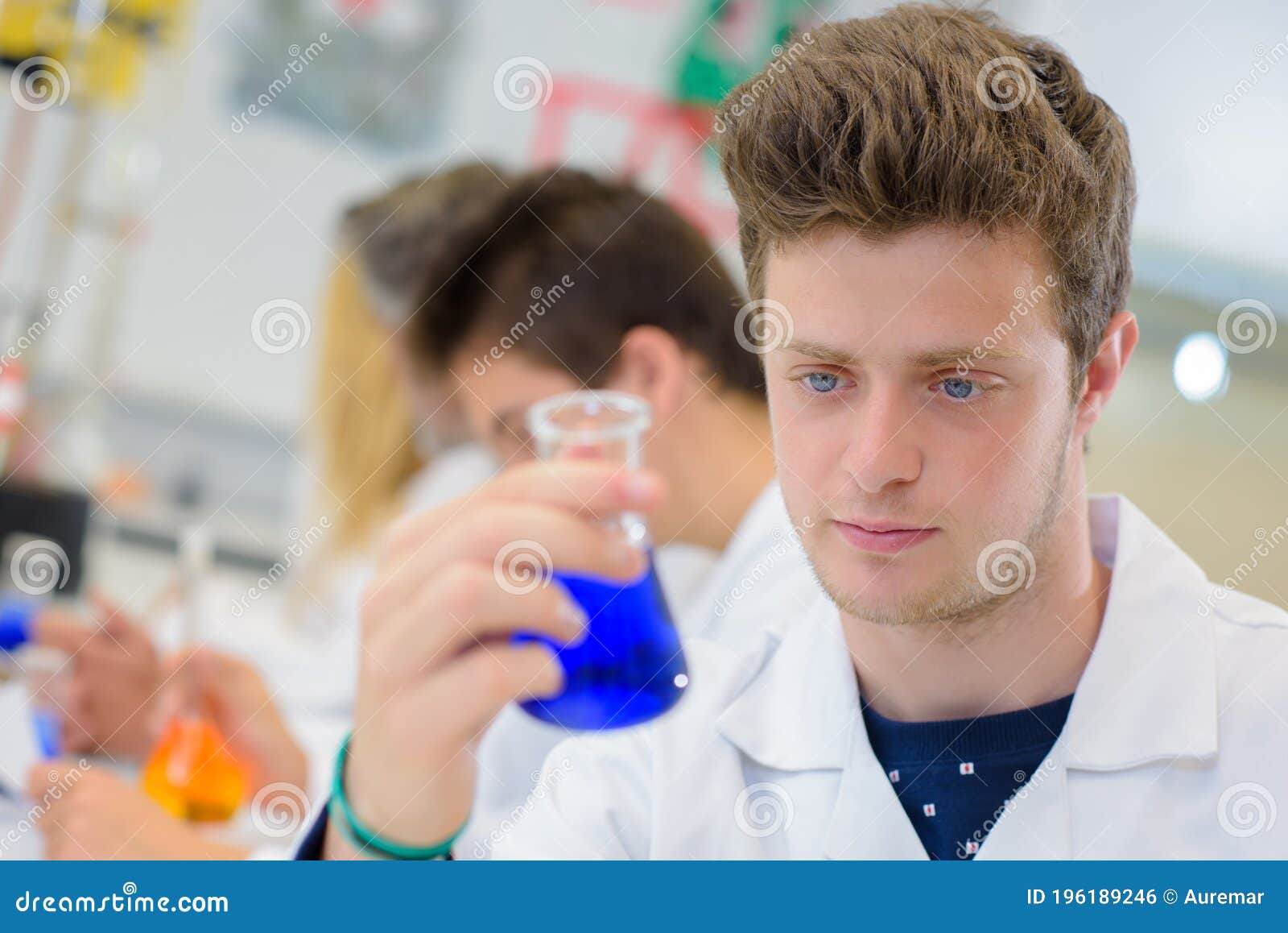 Male Laboratory Student Checking Flask Stock Photo - Image of ...