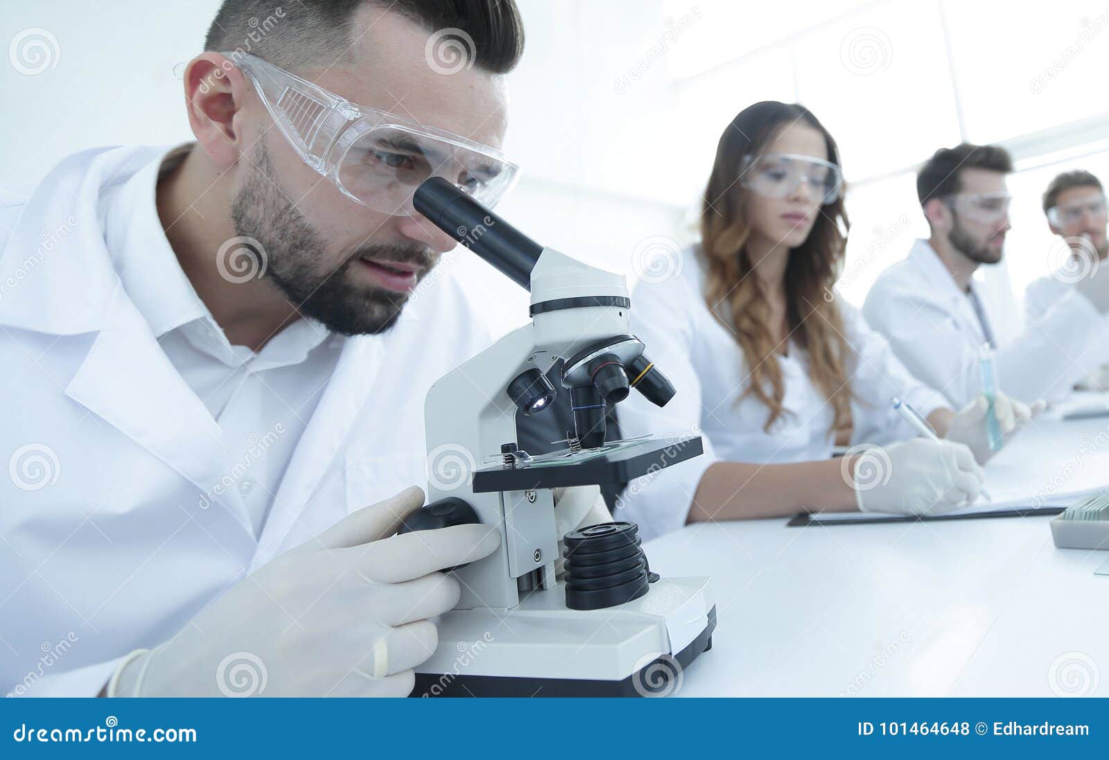 Male Laboratory Technician Looking at Samples in the Microscope Stock ...