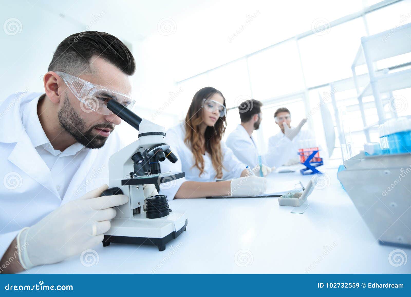 Male Laboratory Technician Looking at Samples in the Microscope Stock ...