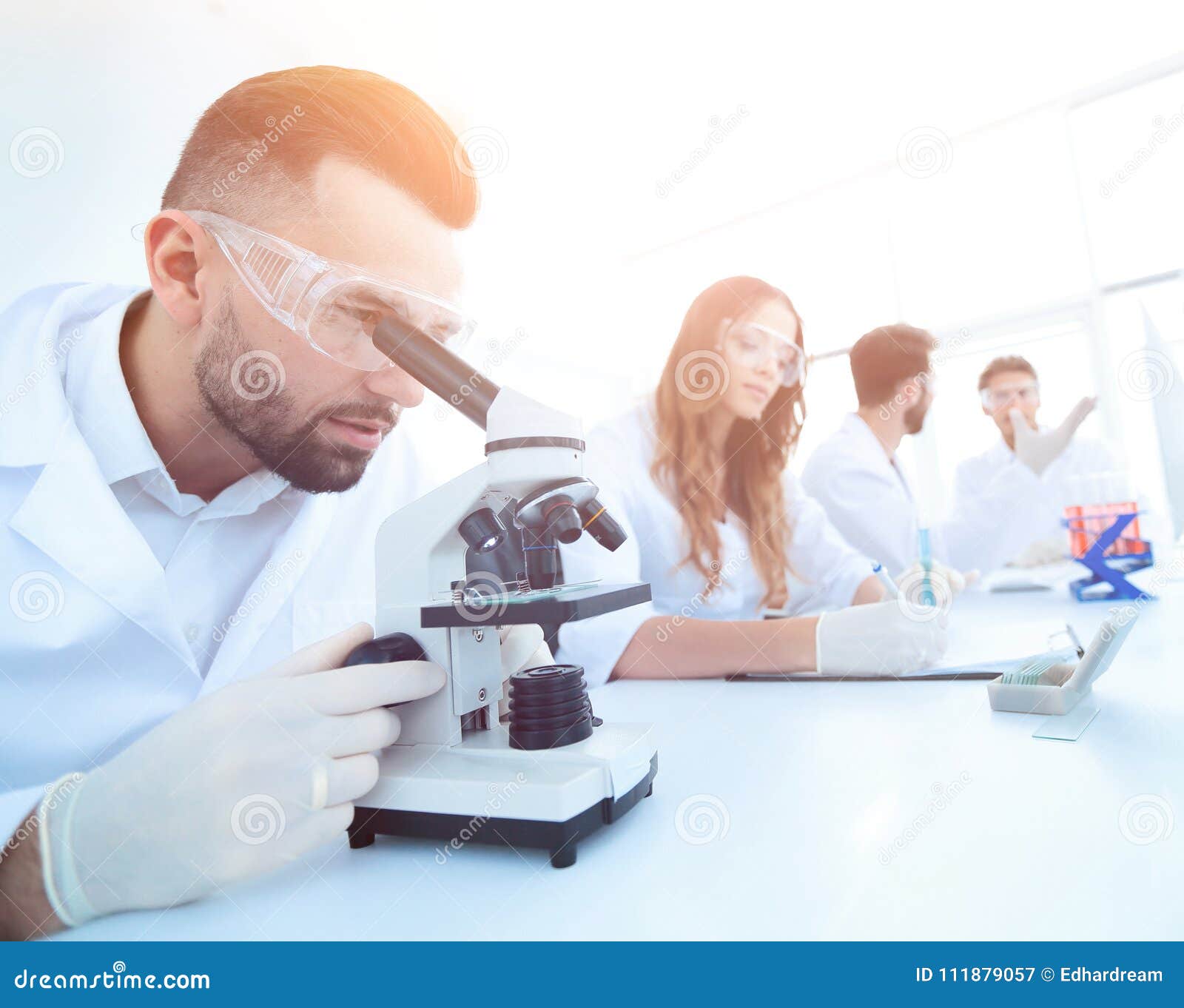 Male Laboratory Technician Looking at Samples in the Microscope Stock ...