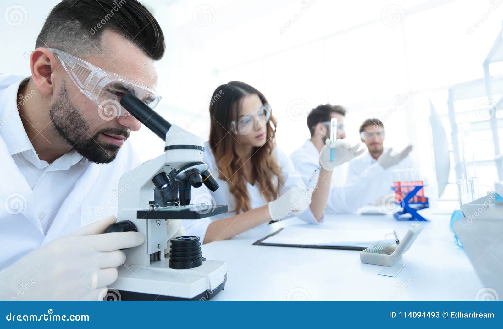 Male Laboratory Technician Looking at Samples in the Microscope Stock ...