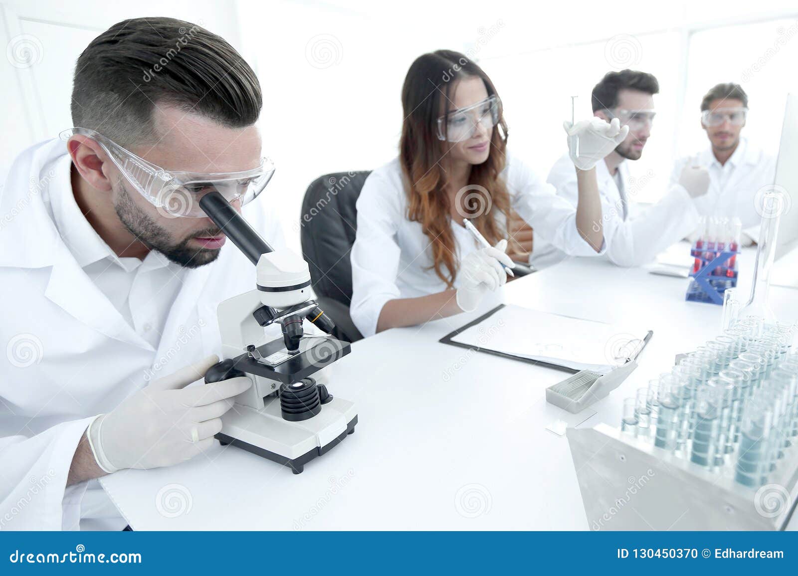 Male Laboratory Technician Looking at Samples in the Microscope Stock ...