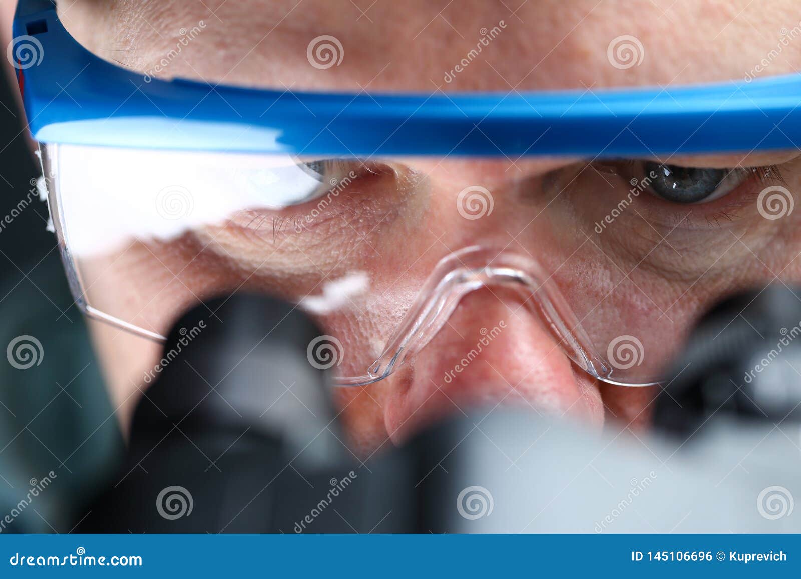 Male Laboratory Worker Eyes Looking At Microscope Wearing Goggles Stock ...