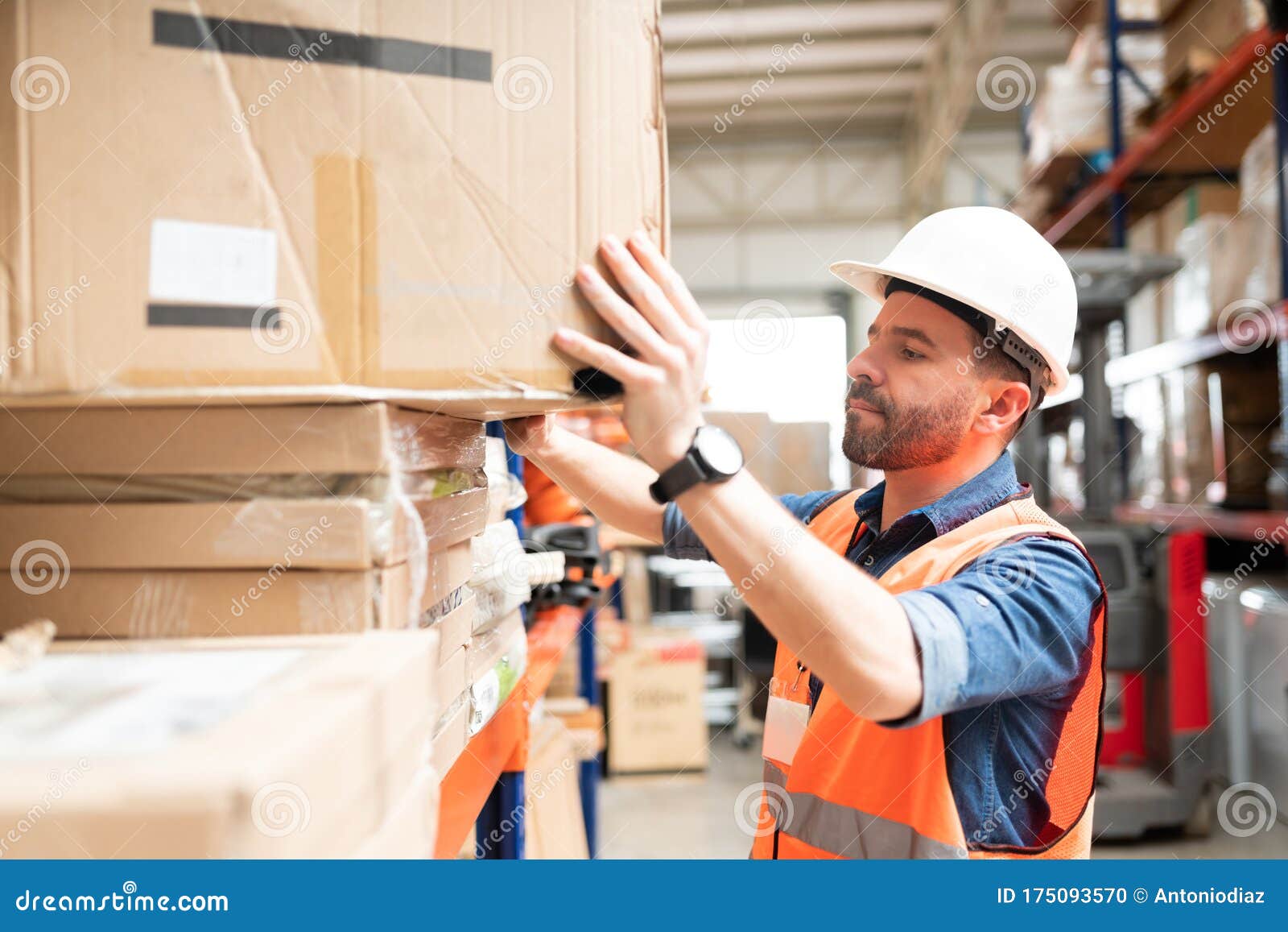 Male Latin Supervisor Positioning Box at Warehouse Stock Photo - Image ...