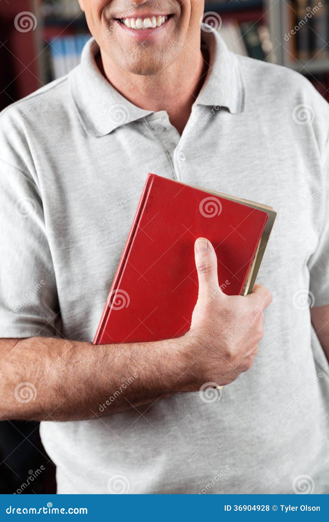 Male Librarian Holding Book in Library Stock Photo - Image of male ...