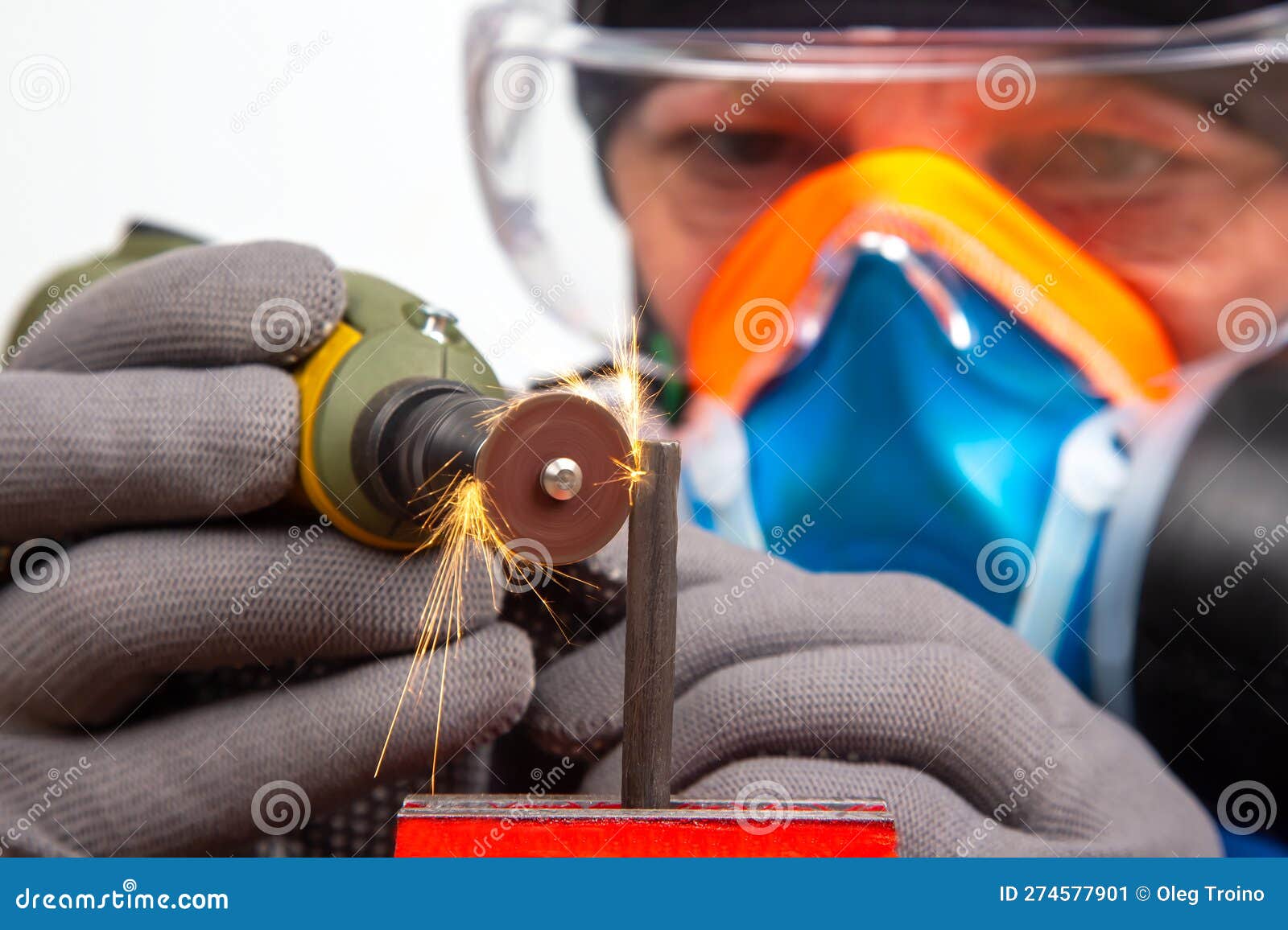 Male Locksmith Worker Processes Metal with Engraving Drill Cutting. the ...