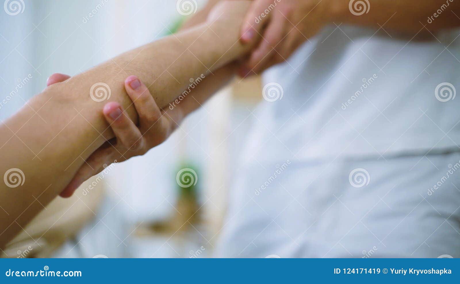 Male Masseur Massaging Beautiful Young Woman Hand On Table In Spa
