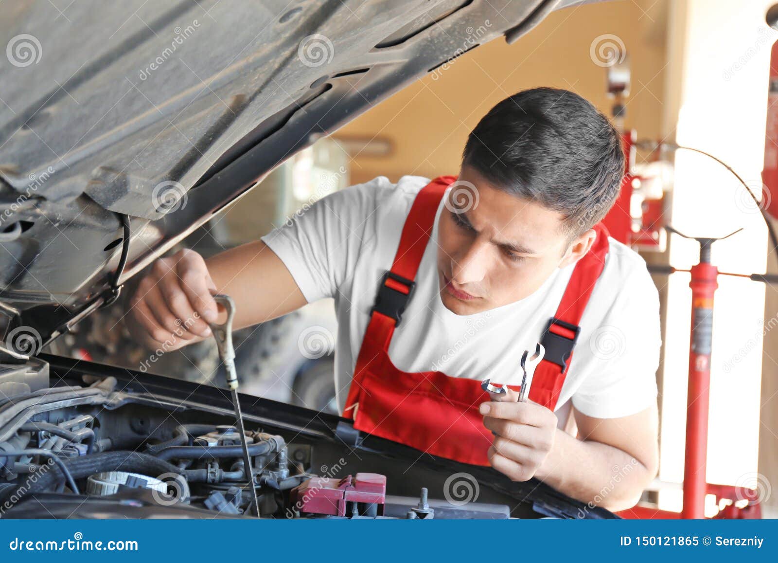 Male Mechanic Checking Level of Oil in Car Engine Stock Image - Image ...