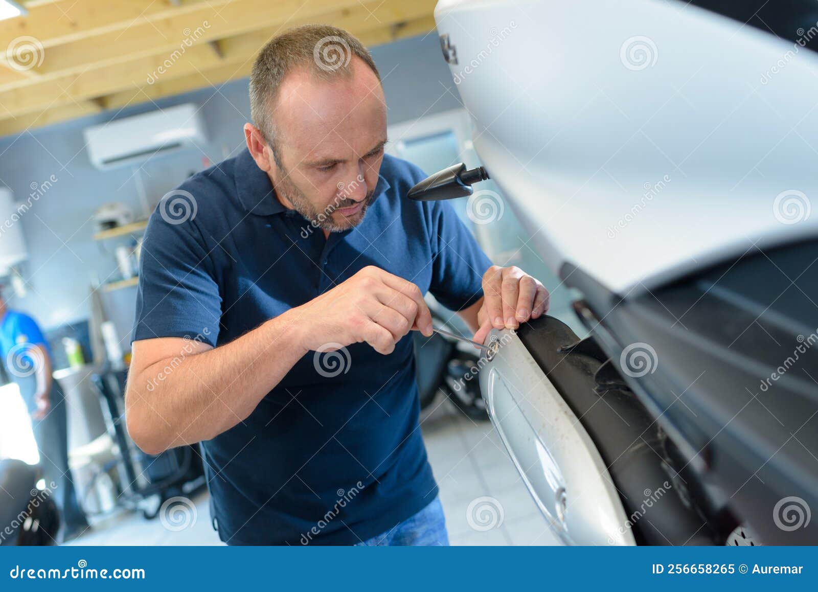 Male Mechanic Using Screwdriver on Silencer Guard Stock Image - Image ...