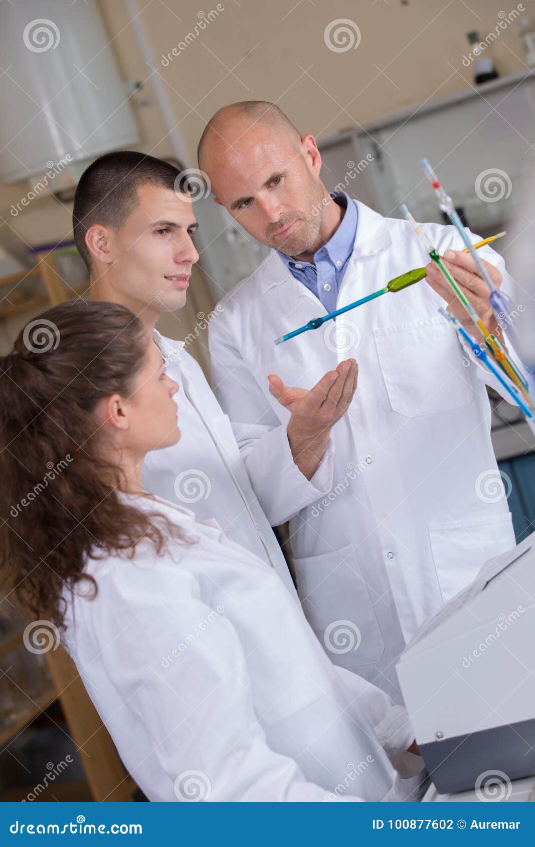 Male Medical Teacher and Students Performing Test Stock Photo - Image ...