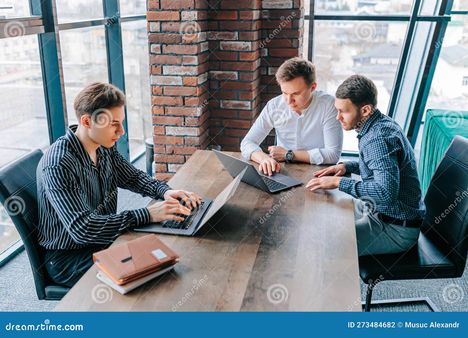 A Male Mentor Leading a Group of Trainees through a Presentation on ...