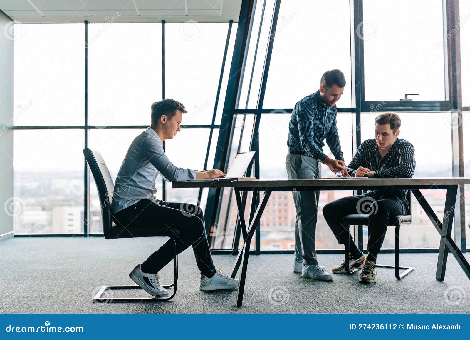 A Male Mentor Offering Guidance To a Trainee on How To Complete a Work ...
