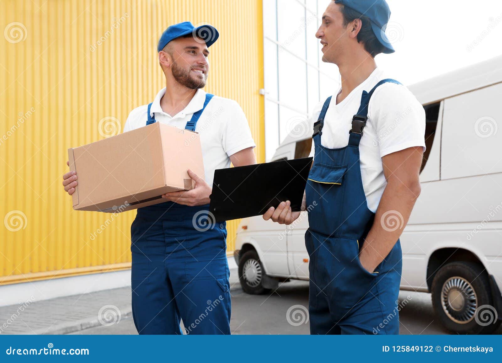 Male Movers with Box and Clipboard Stock Photo - Image of moving, move ...