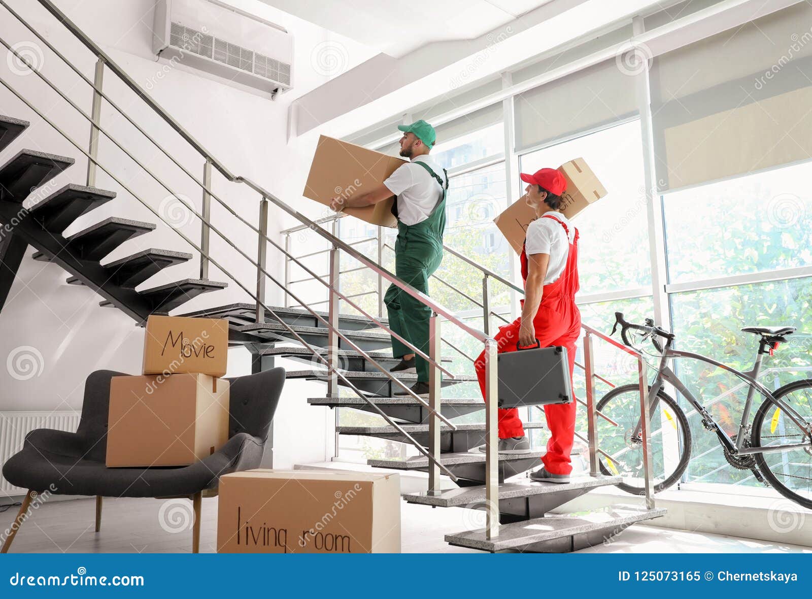 Male movers carrying boxes stock image. Image of experts - 125073165