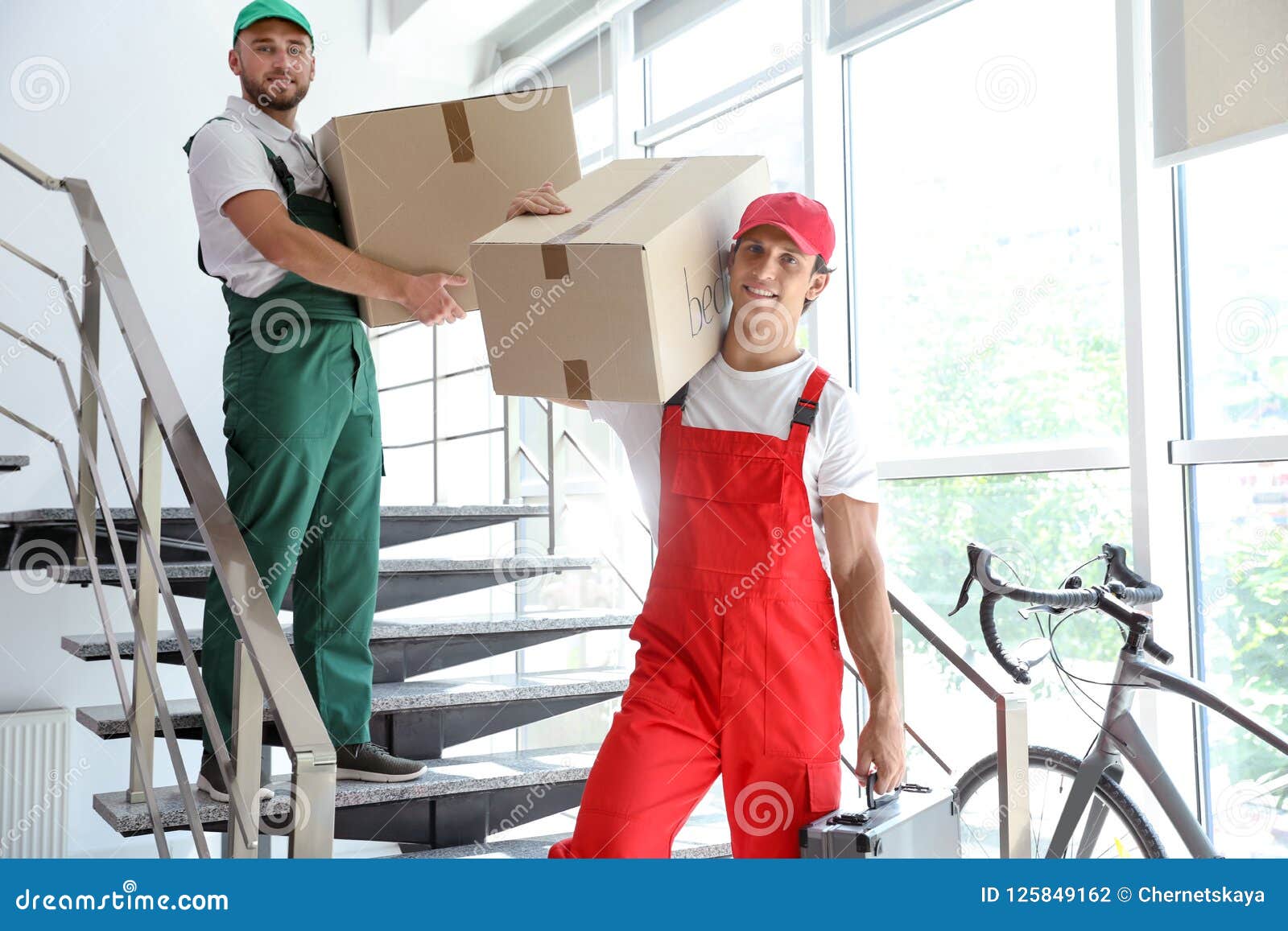 Male movers carrying boxes stock photo. Image of boxes - 125849162