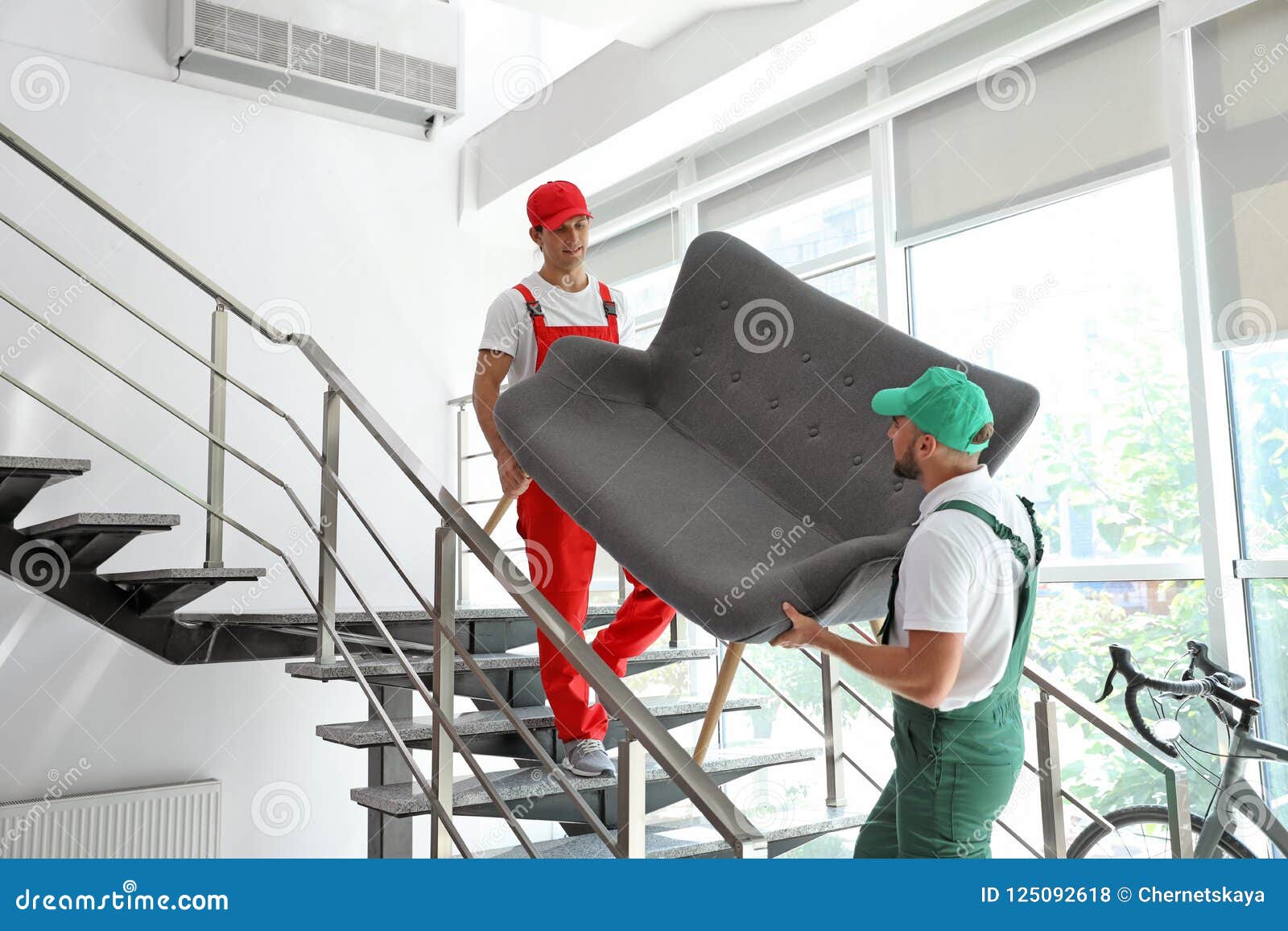 Male Movers Carrying Sofa in House Stock Photo - Image of house ...