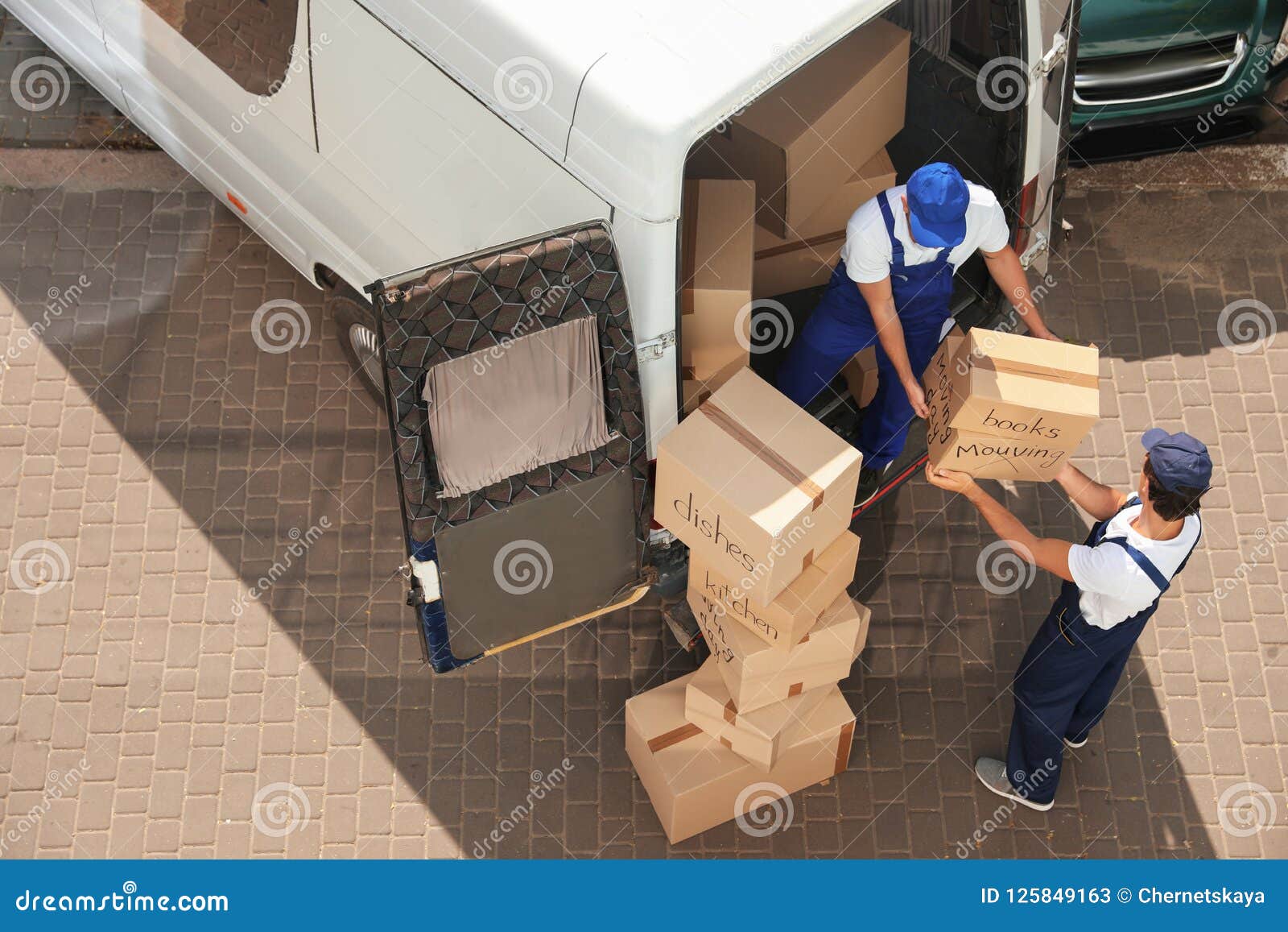 Male Movers Unloading Boxes from Van Outdoors Stock Image - Image of ...