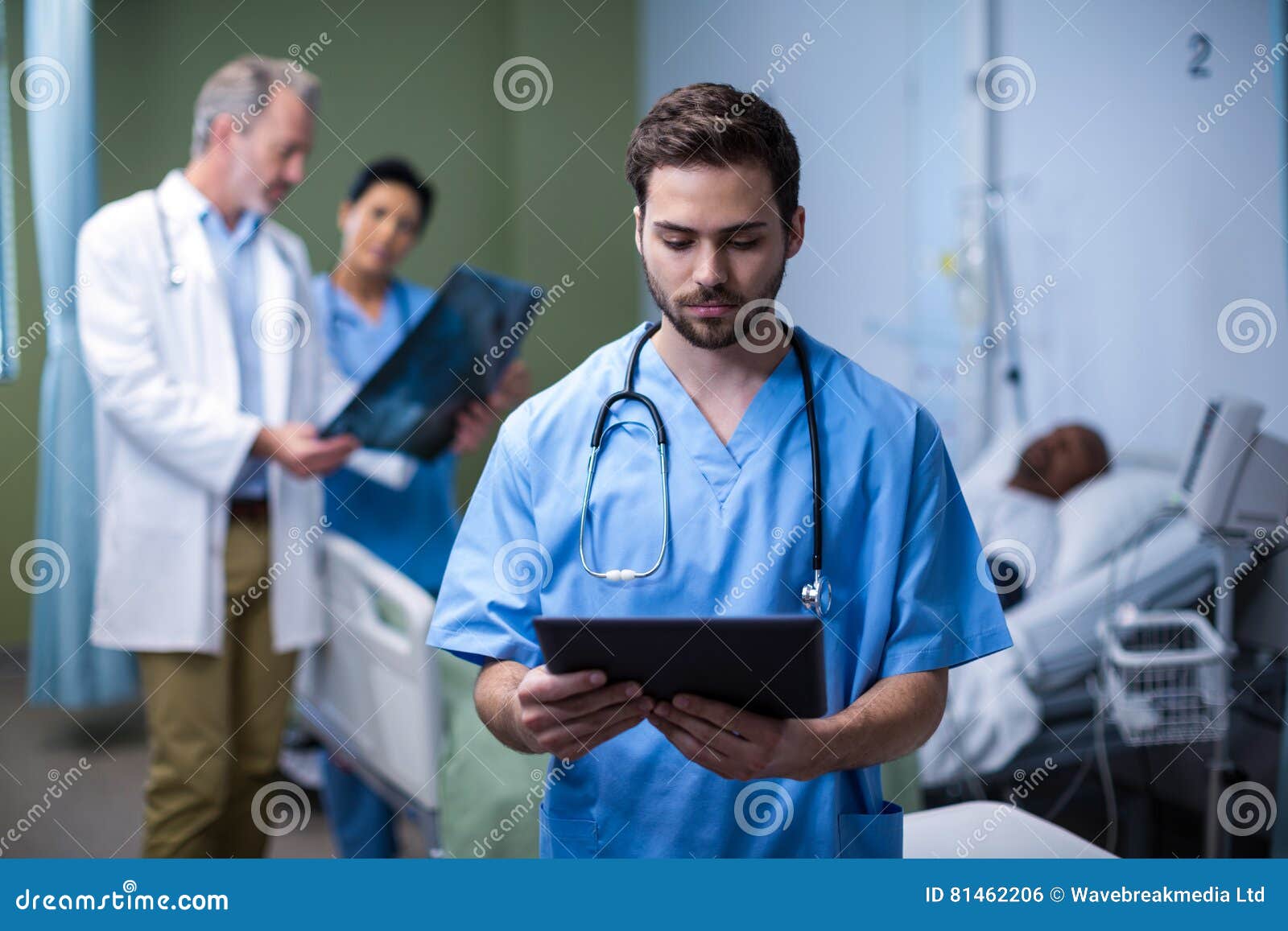 Male Nurse Using Digital Tablet in Ward Stock Photo - Image of ...