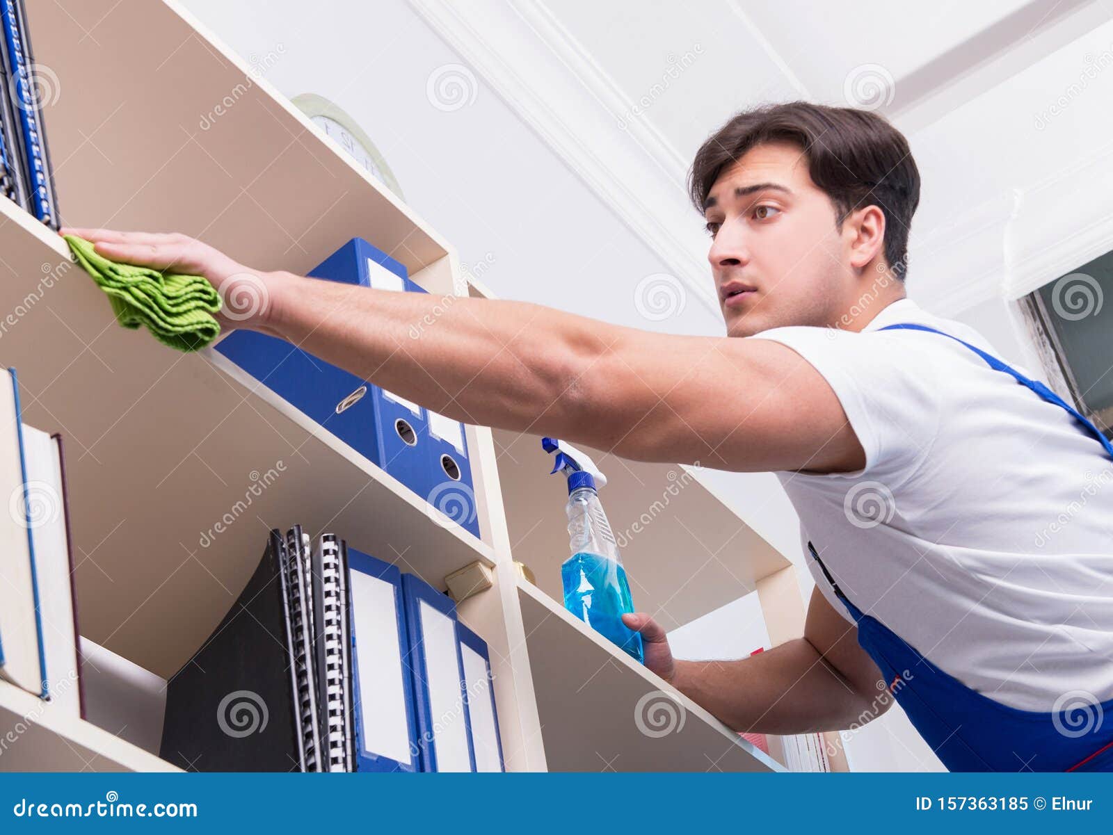 Male Office Cleaner Cleaning Shelves in Office Stock Image - Image of ...