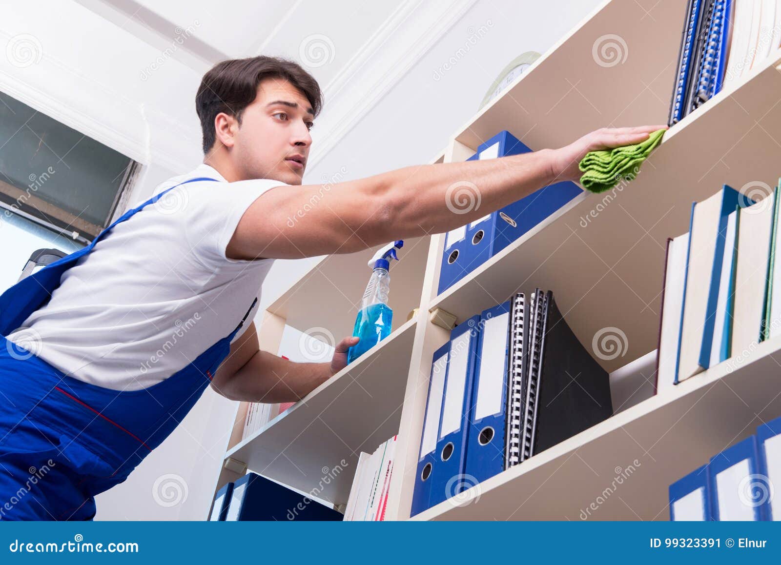 The Male Office Cleaner Cleaning Shelves in Office Stock Image - Image ...
