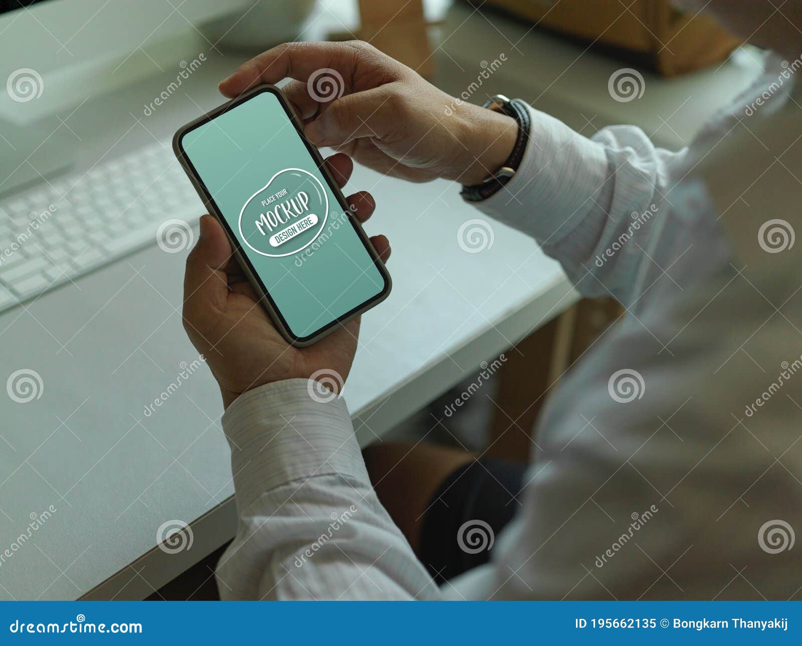 Male Office Worker Using Mock Up Smartphone at Computer Desk Stock ...