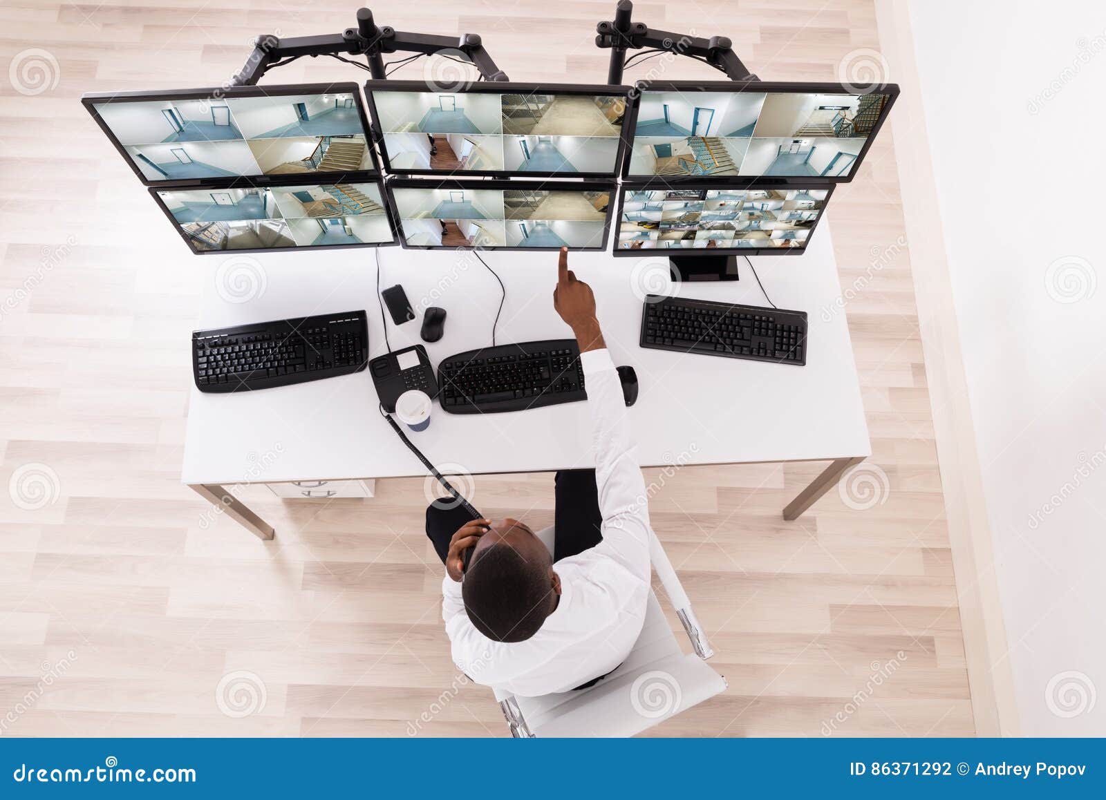Male Operator Pointing at CCTV Footage on Computer Stock Photo - Image ...