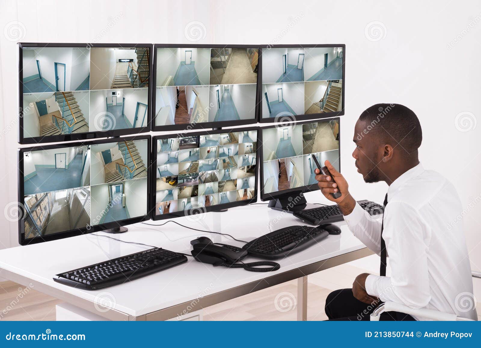 Male Operator Talking on Walkie-Talkie Stock Photo - Image of room ...