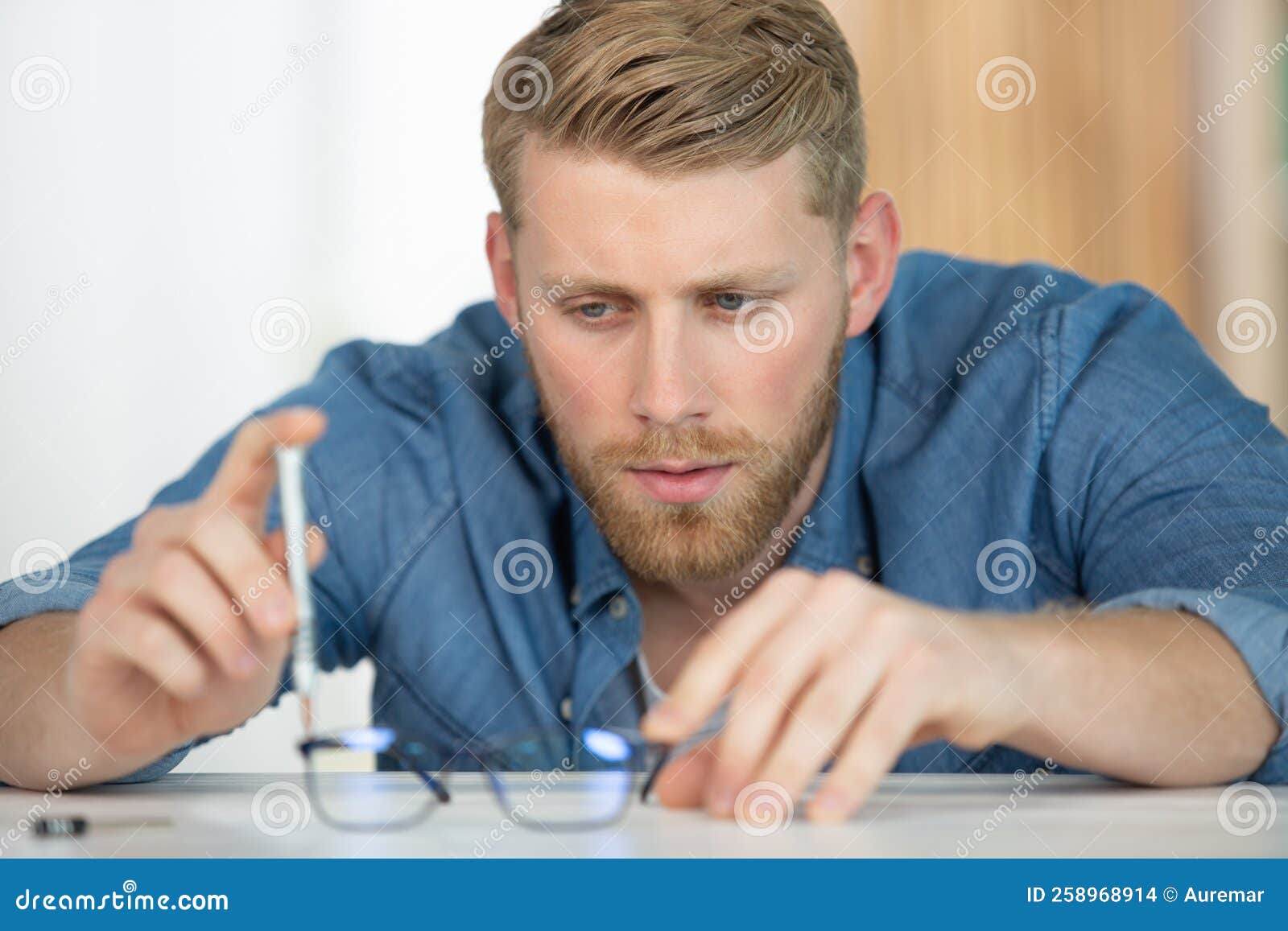 Male Optician Fixing Glasses with Pliers Stock Photo - Image of reading ...