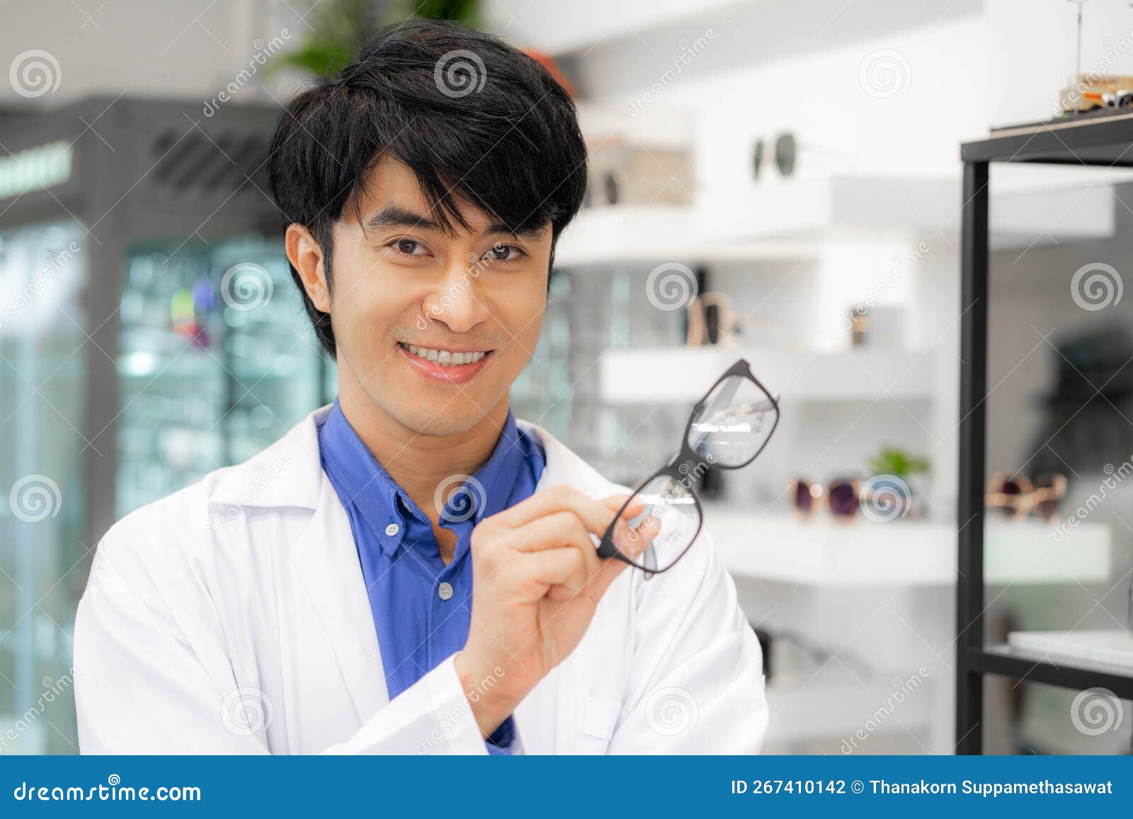 Male Optician Standing with a Eyeglasses in Optical Store Stock Photo ...