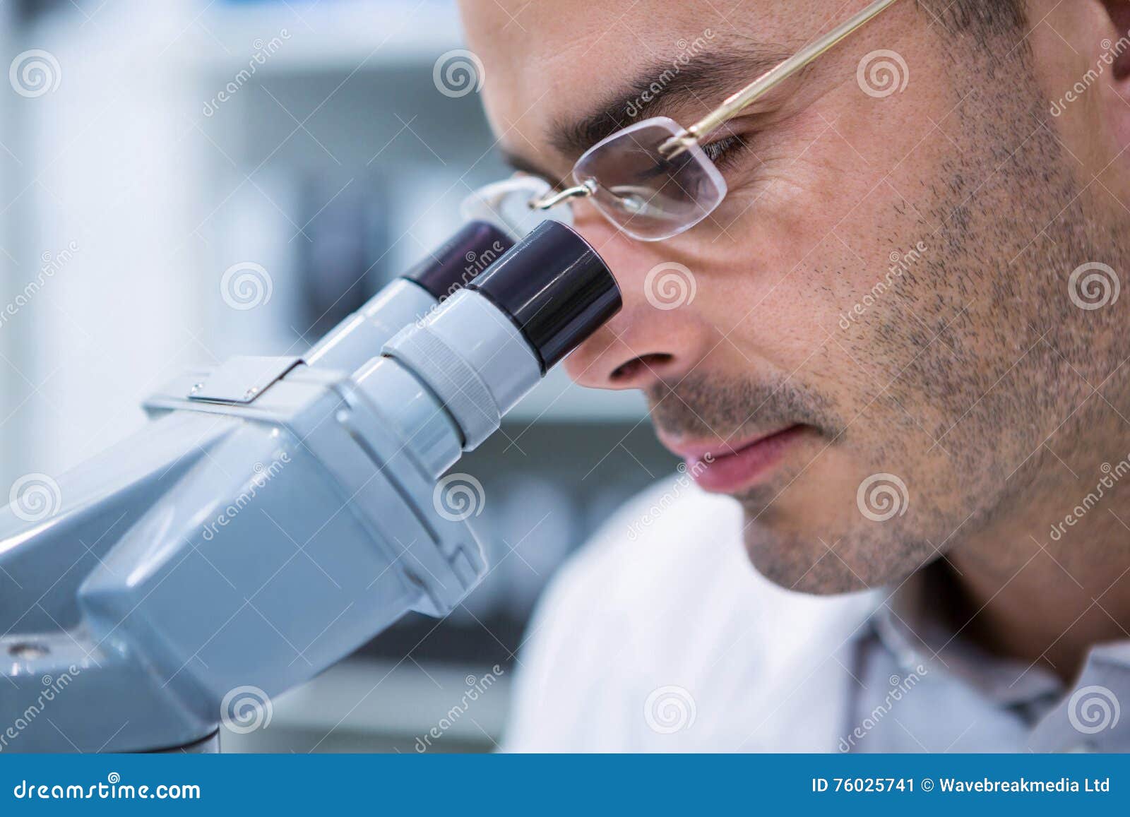 Male Optometrist Looking through Microscope Stock Image - Image of ...