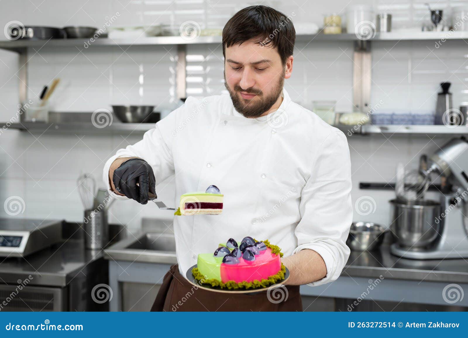 Male Pastry Chef Holds a Cut Mousse Cake in His Hands. Stock Photo ...