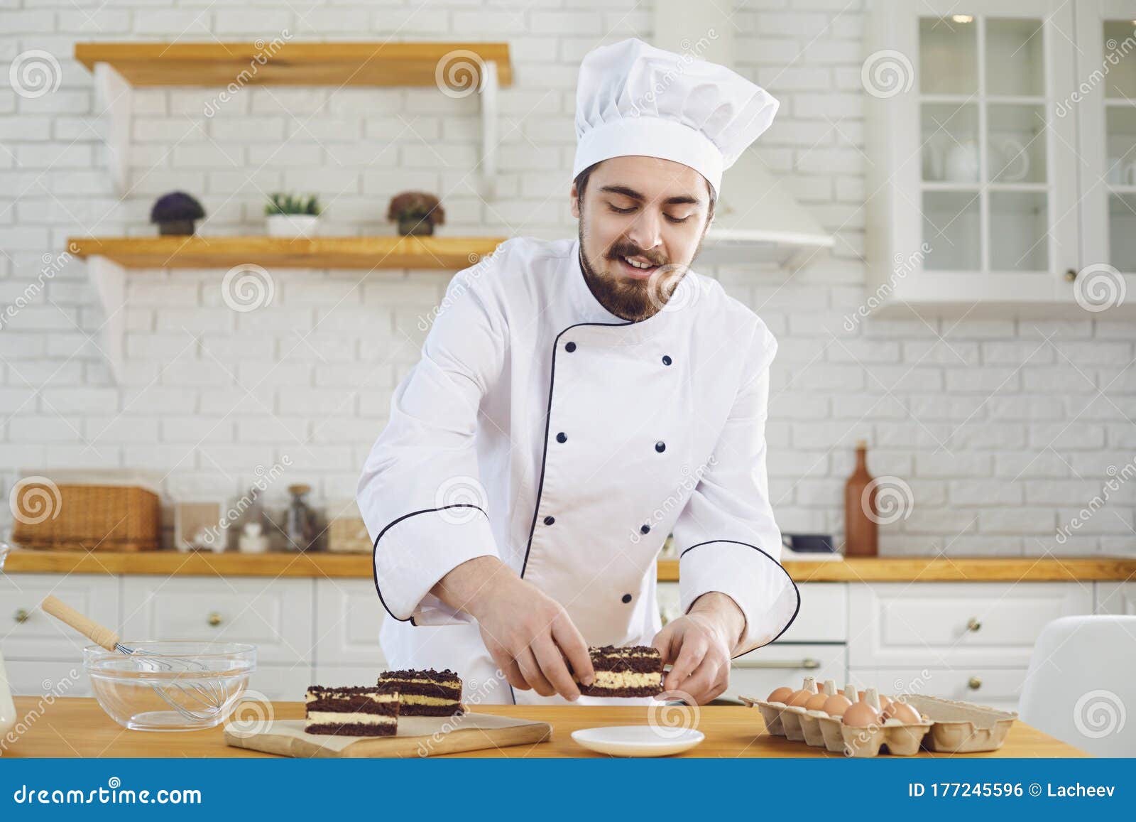 A Male Pastry Chef Works Decorating a Cake on a Kitchen Bakery Stock ...