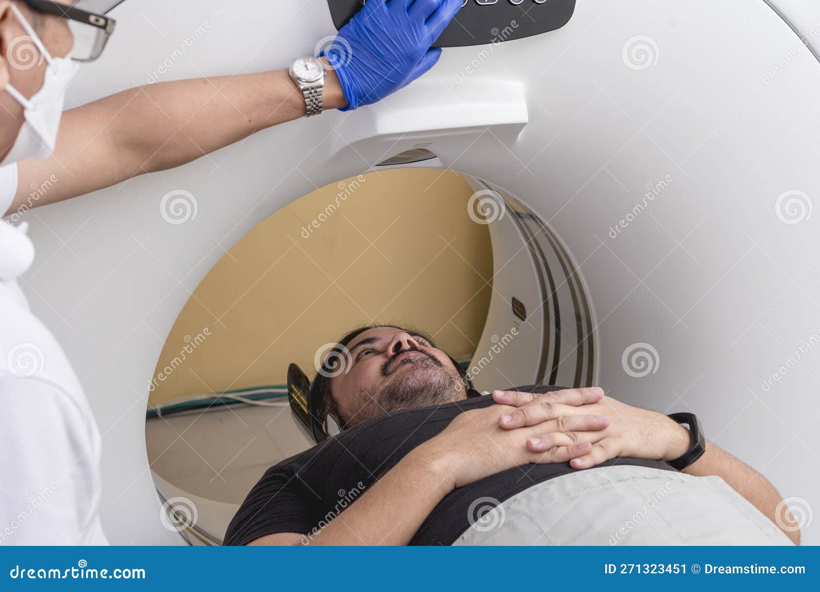 A Male Patient Goes Inside a CT Scan Gantry Operated by a Technician ...