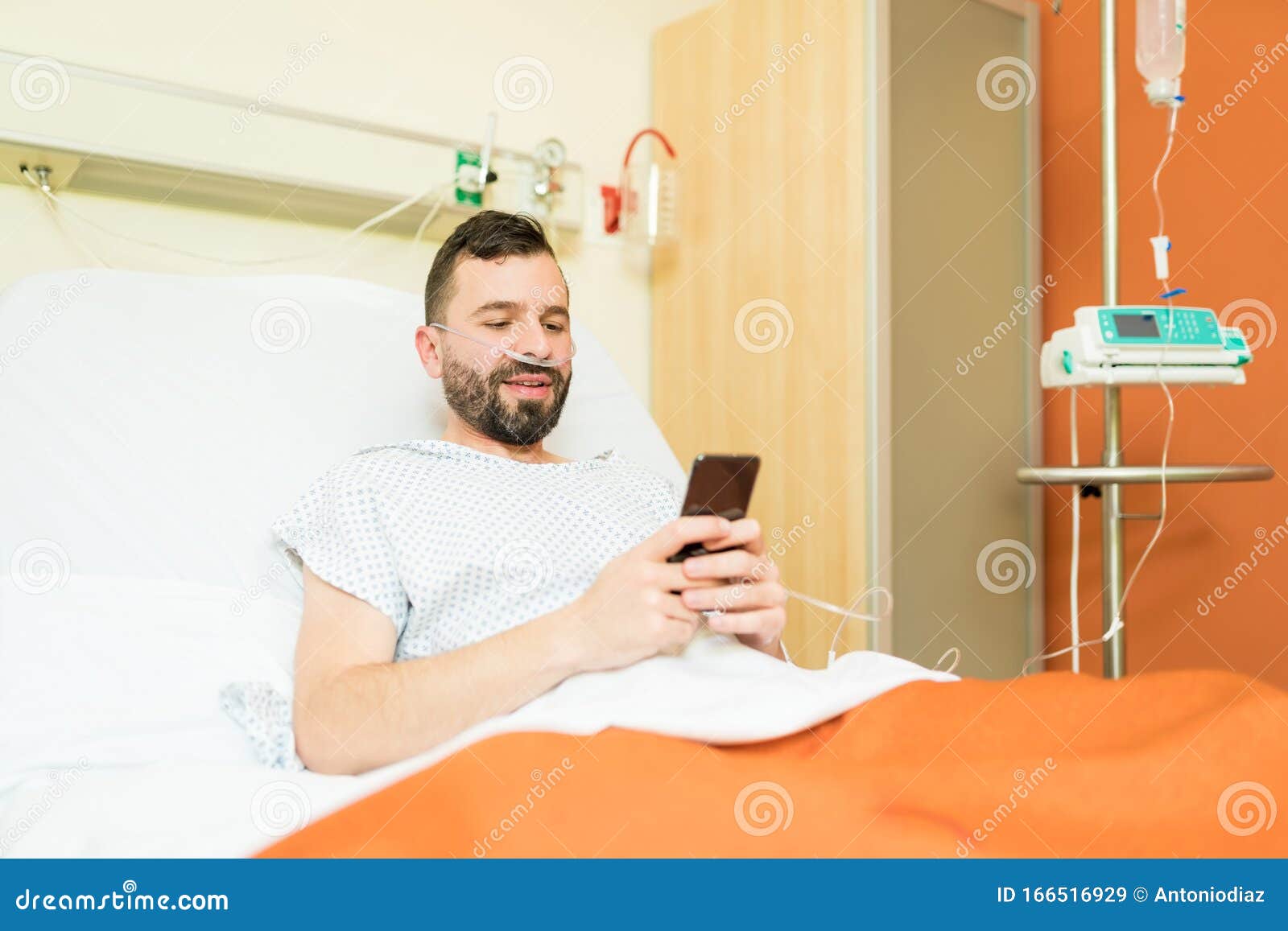 Male Patient Texting on Cellphone in Hospital Stock Image - Image of ...