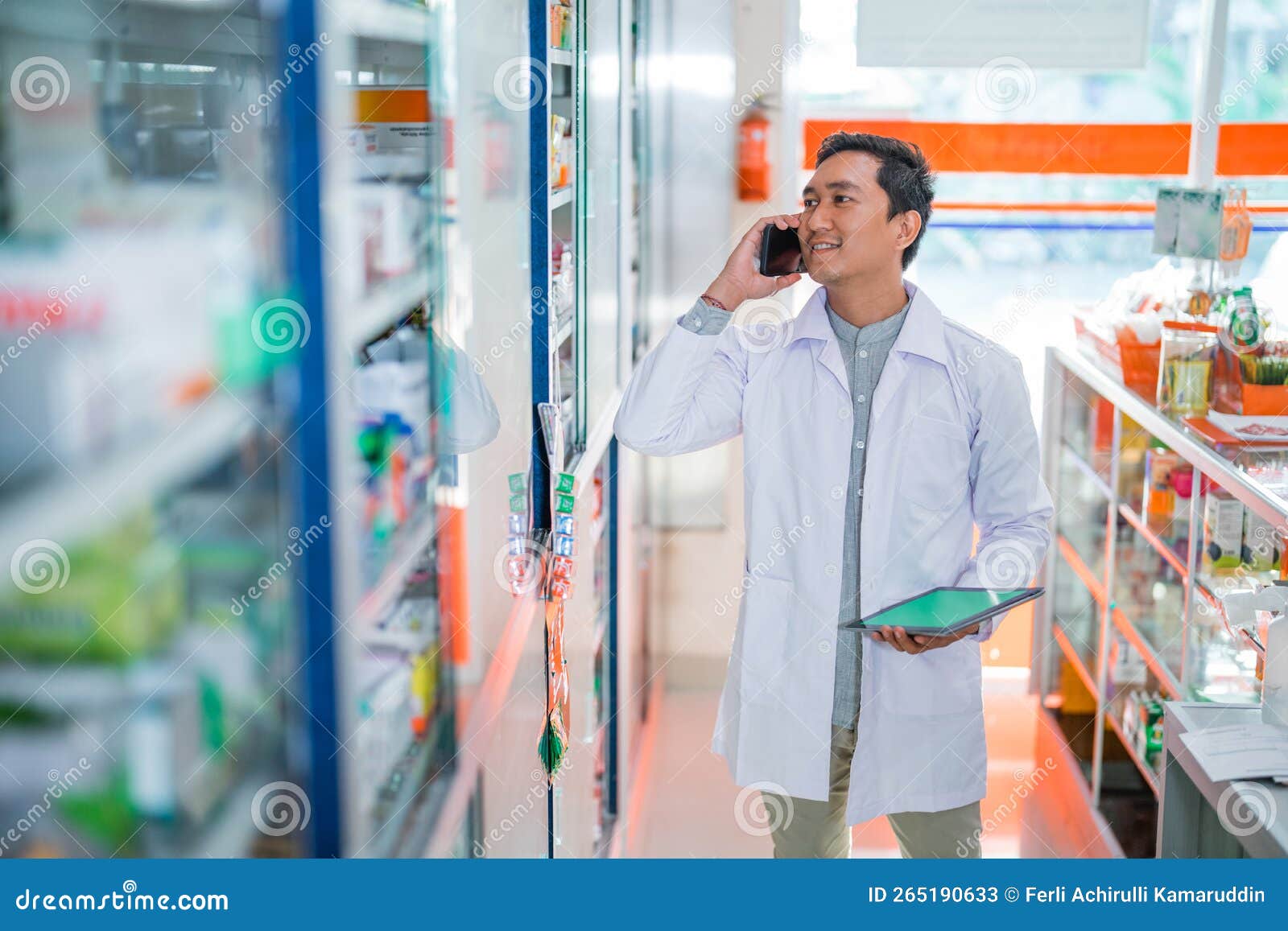 Male Pharmacist in Uniform Making Phone Call while Holding Pad Stock ...