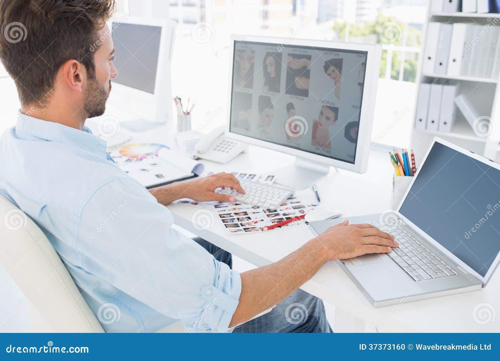 Male Photo Editor Working on Computer in a Bright Office Stock Photo ...