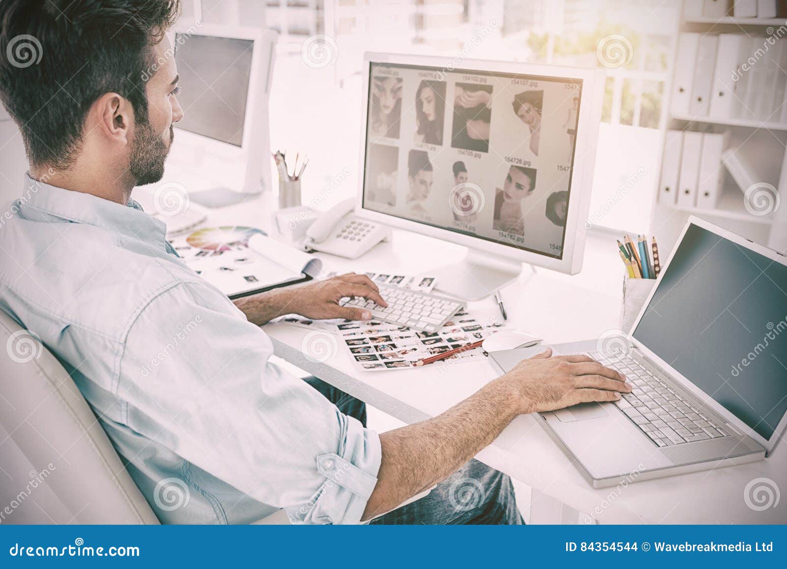 Male Photo Editor Working on Computer in a Bright Office Stock Photo ...