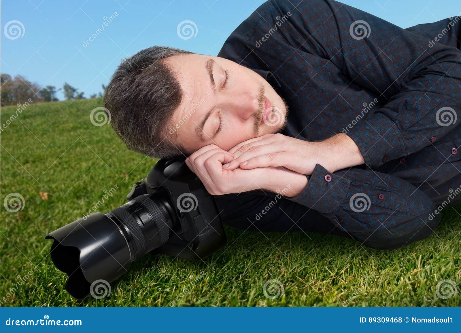 Male Photographer with Camera Sleeping on Meadow Stock Photo - Image of ...