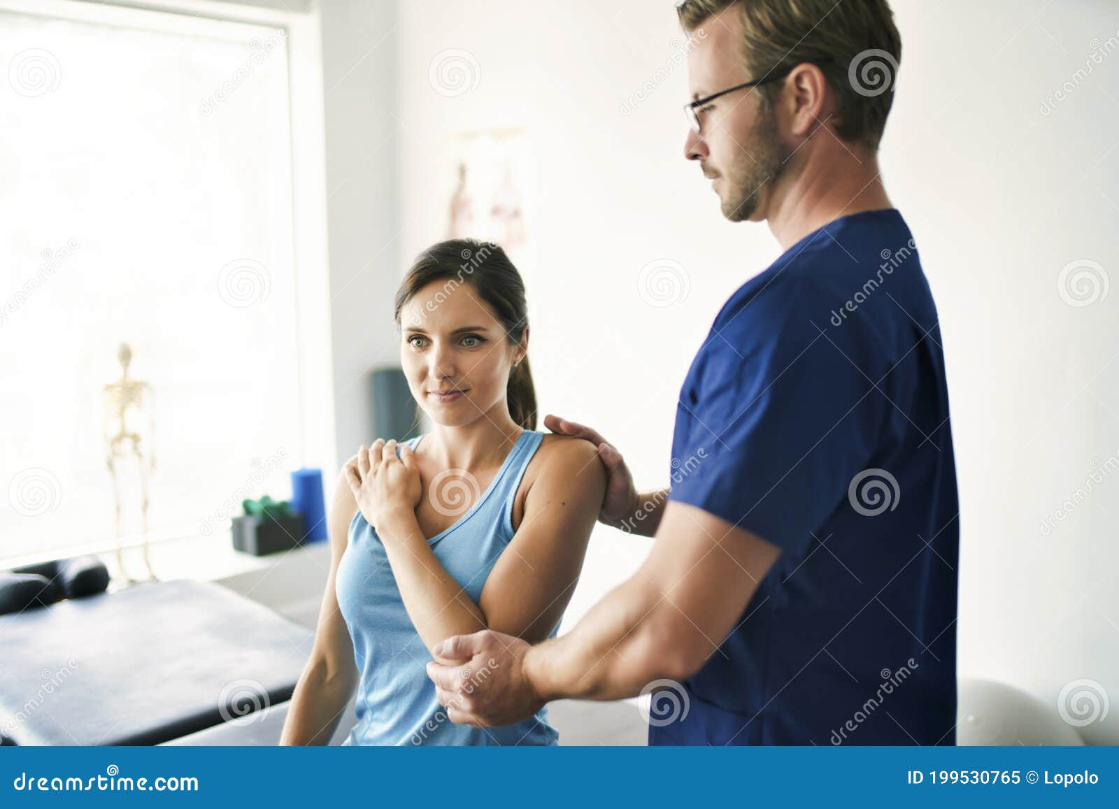 Male Physical Therapist Stretching a Female Patient Stock Image - Image ...
